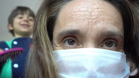 Face of mother in mask and a child combi... | Stock Video | Pond5