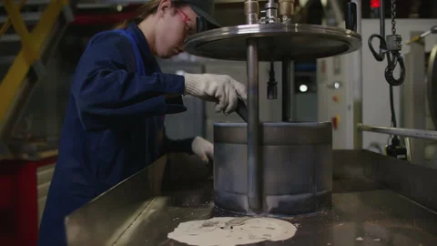 Factory worker clean metal scrap from ve... | Stock Video | Pond5