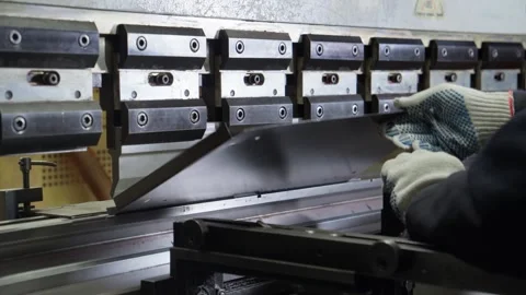 Factory worker puts metal sheet in bendi... | Stock Video | Pond5