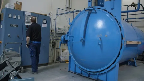 Factory worker starting big autoclave on... | Stock Video | Pond5