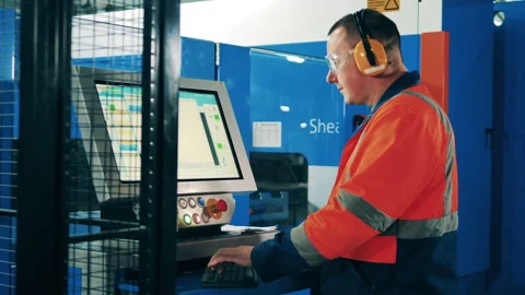 Factory worker using computer to control... | Stock Video | Pond5