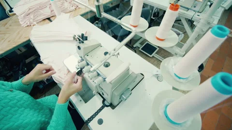 Factory worker is using a sewing machine... | Stock Video | Pond5