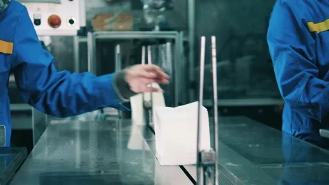 Factory workers are putting paper tissue... | Stock Video | Pond5