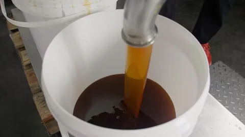 Factory workers filling out pails with h... | Stock Video | Pond5
