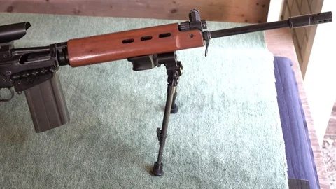 FAL rifle sitting idly on shooting range... | Stock Video | Pond5