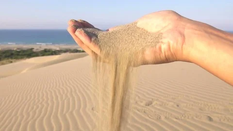 Falling beach sand from woman hands | Stock Video | Pond5