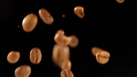 Falling coffee beans on the black backgr... | Stock Video | Pond5