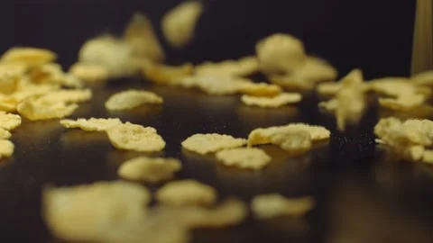 Falling corn flakes on a black backgroun... | Stock Video | Pond5