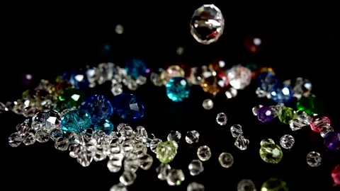 Falling crystals on a black background. ... | Stock Video | Pond5