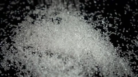 Falling grains of sugar on a black mirro... | Stock Video | Pond5