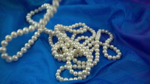 Falling pearls jewelry on a navy blue si... | Stock Video | Pond5