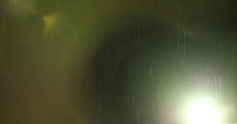 Falling rain with lens flare hitting cam... | Stock Video | Pond5
