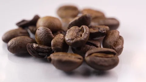 Falling roasted coffee beans in slow mot... | Stock Video | Pond5
