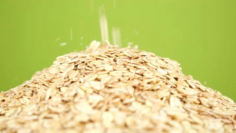 Falling rolled oat grains in raw oatmeal... | Stock Video | Pond5