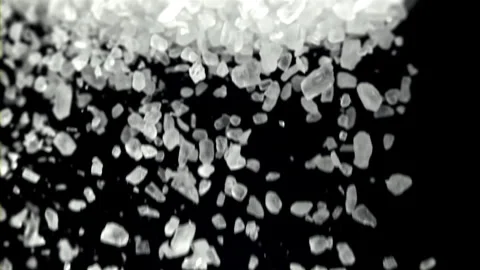 Falling salt crystals on a black backgro... | Stock Video | Pond5
