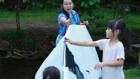 Family camping outdoor, child helping mo... | Stock Video | Pond5