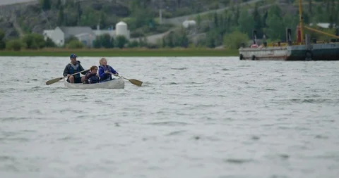 Family in canoe paddling in choppy water... | Stock Video | Pond5