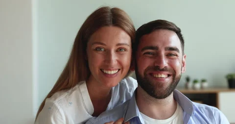 Family couple cuddling looking at camera... | Stock Video | Pond5