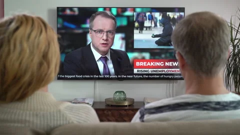 Family Couple Watching TV News Sitting o... | Stock Video | Pond5