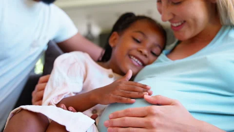 Family With Daughter Cuddling Pregnant M... | Stock Video | Pond5