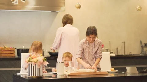 A family of four cooks all together. The... | Stock Video | Pond5