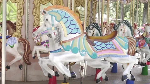 Family rides on the carousel on horsebac... | Stock Video | Pond5