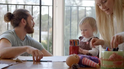Family Sitting At Table And Drawing Pict... | Stock Video | Pond5