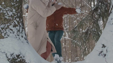 Family of Three Playing Snowballs in Win... | Stock Video | Pond5