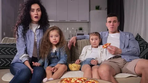 Family watches horror movie together and... | Stock Video | Pond5