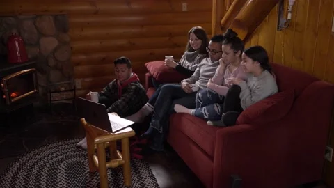 Family watching movie on laptop in log c... | Stock Video | Pond5