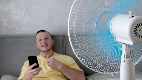 Fan cools the person from the heat. The ... | Stock Video | Pond5