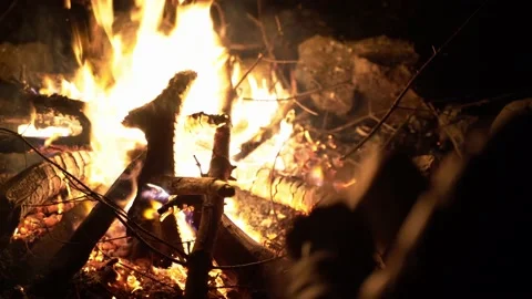 Fanning flames of the fire cooking marsh... | Stock Video | Pond5