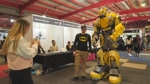 Fans greet and pose with Bumblebee costu... | Stock Video | Pond5