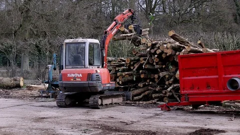 Farm machine grabbing tree trunks to be ... | Stock Video | Pond5