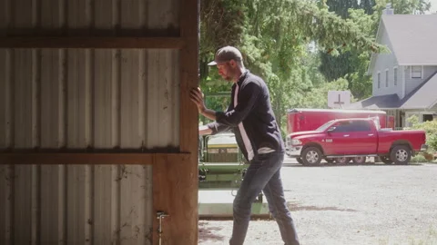 Farmer Opening a Barn Door | Stock Video | Pond5