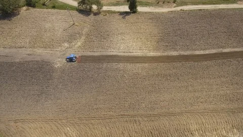 Farmer on tractor plowing a field in Umb... | Stock Video | Pond5