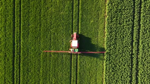 Farming tractor spraying on field with s... | Stock Video | Pond5