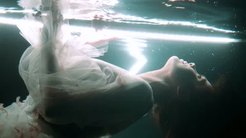 fascinating lady is floating underwater,... | Stock Video | Pond5