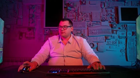 The Fat gamer plays at the computer and ... | Stock Video | Pond5
