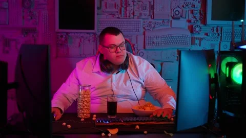 The Fat gamer plays at the computer and ... | Stock Video | Pond5