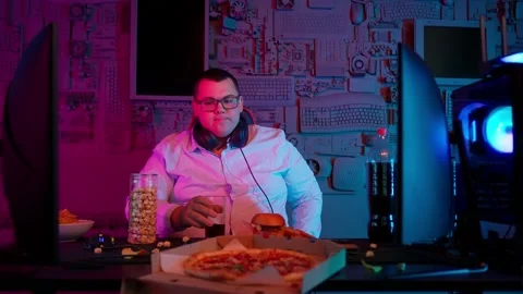 The Fat gamer plays at the computer and ... | Stock Video | Pond5