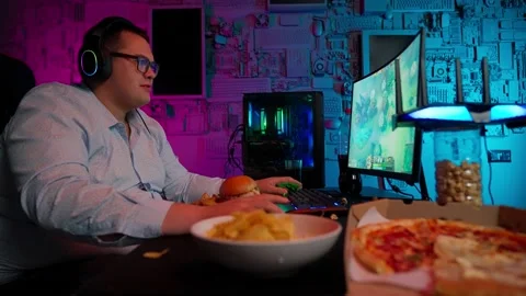 The Fat gamer plays at the computer and ... | Stock Video | Pond5