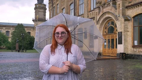 Fat ginger girl with glasses is standing... | Stock Video | Pond5
