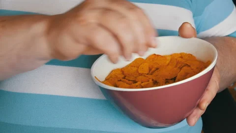 Fat, lazy man is eating potato chips sit... | Stock Video | Pond5