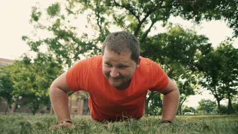 Fat male trying to do push up exercise a... | Stock Video | Pond5