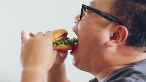 Fat man enjoy to eat unhealthy junk food... | Stock Video | Pond5