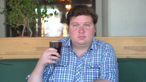 Fat man holding a glass of soft drink co... | Stock Video | Pond5