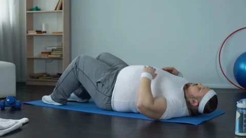 Fat man practicing abdominal static exer... | Stock Video | Pond5