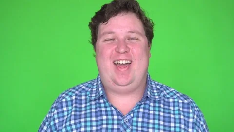 Fat man smiles and laughs, on a green sc... | Stock Video | Pond5