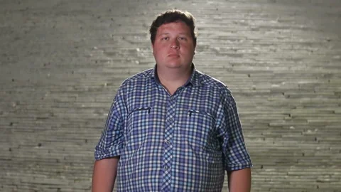 Fat man standing and looking at camera i... | Stock Video | Pond5